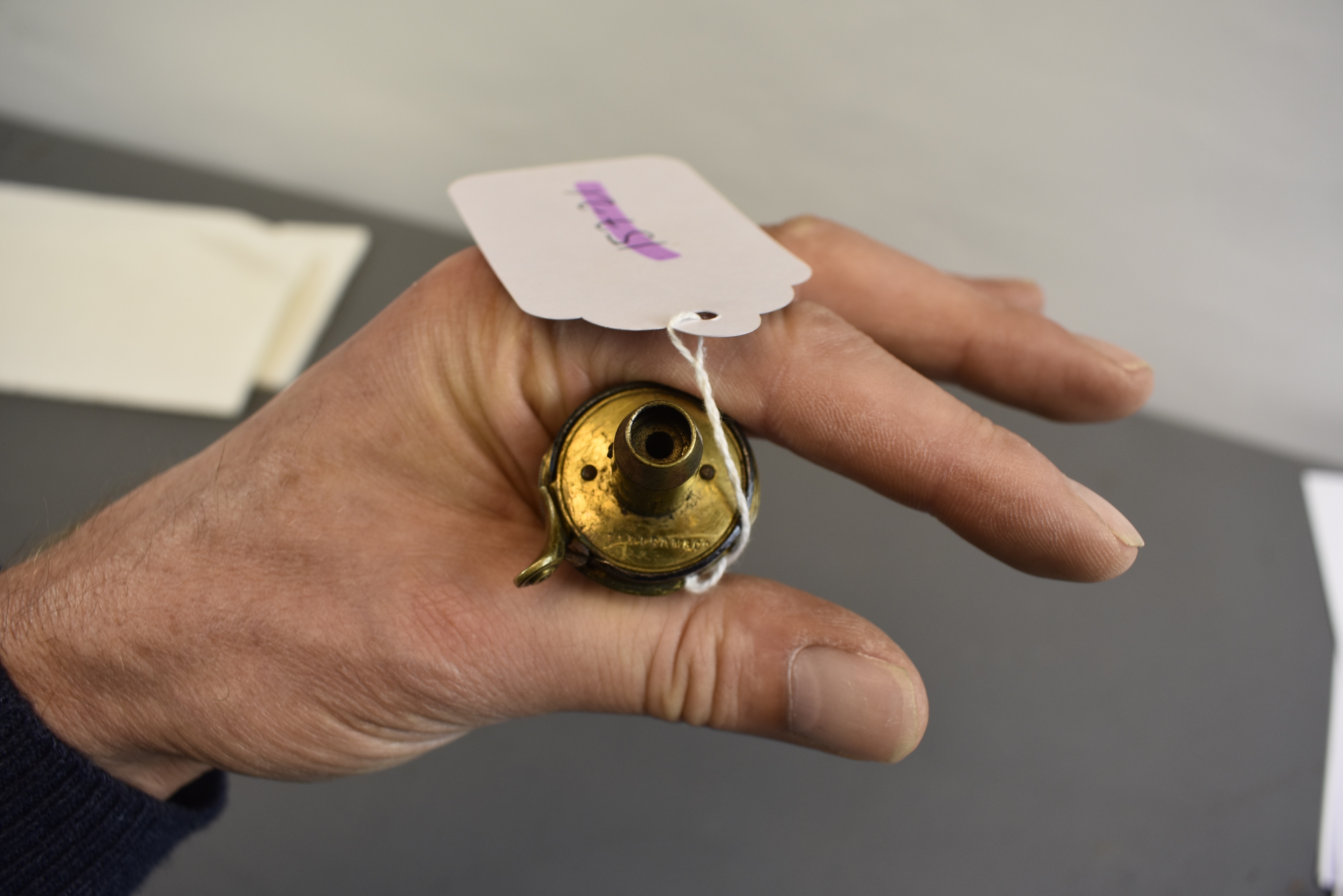 Lot 502 - AN ENGLISH BAG SHAPED COLT POWDER FLASK BY